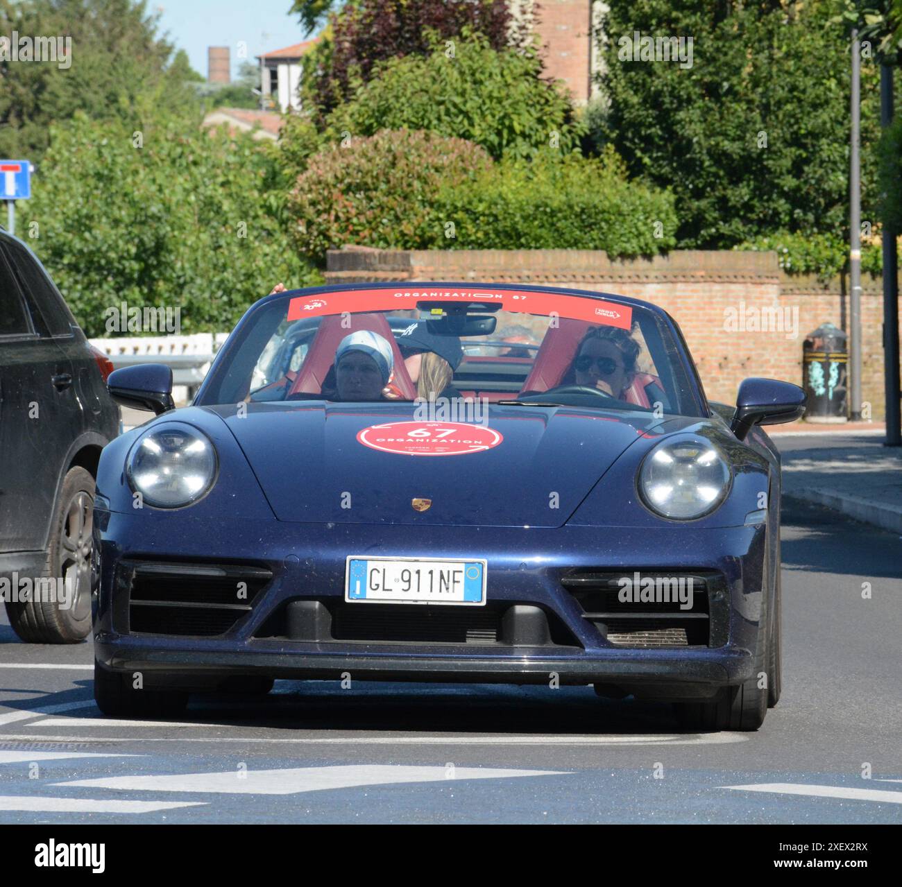 FERRARA , ITALY - jun 15 -2024 : A classic car races through the ...
