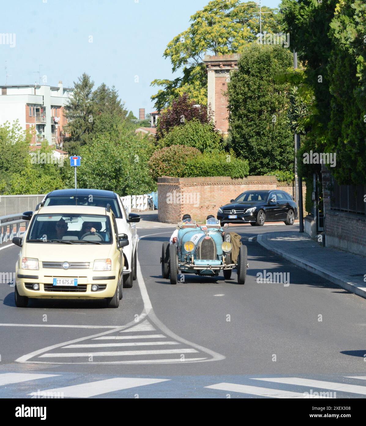 FERRARA , ITALY - jun 15 -2024 : A classic car races through the ...