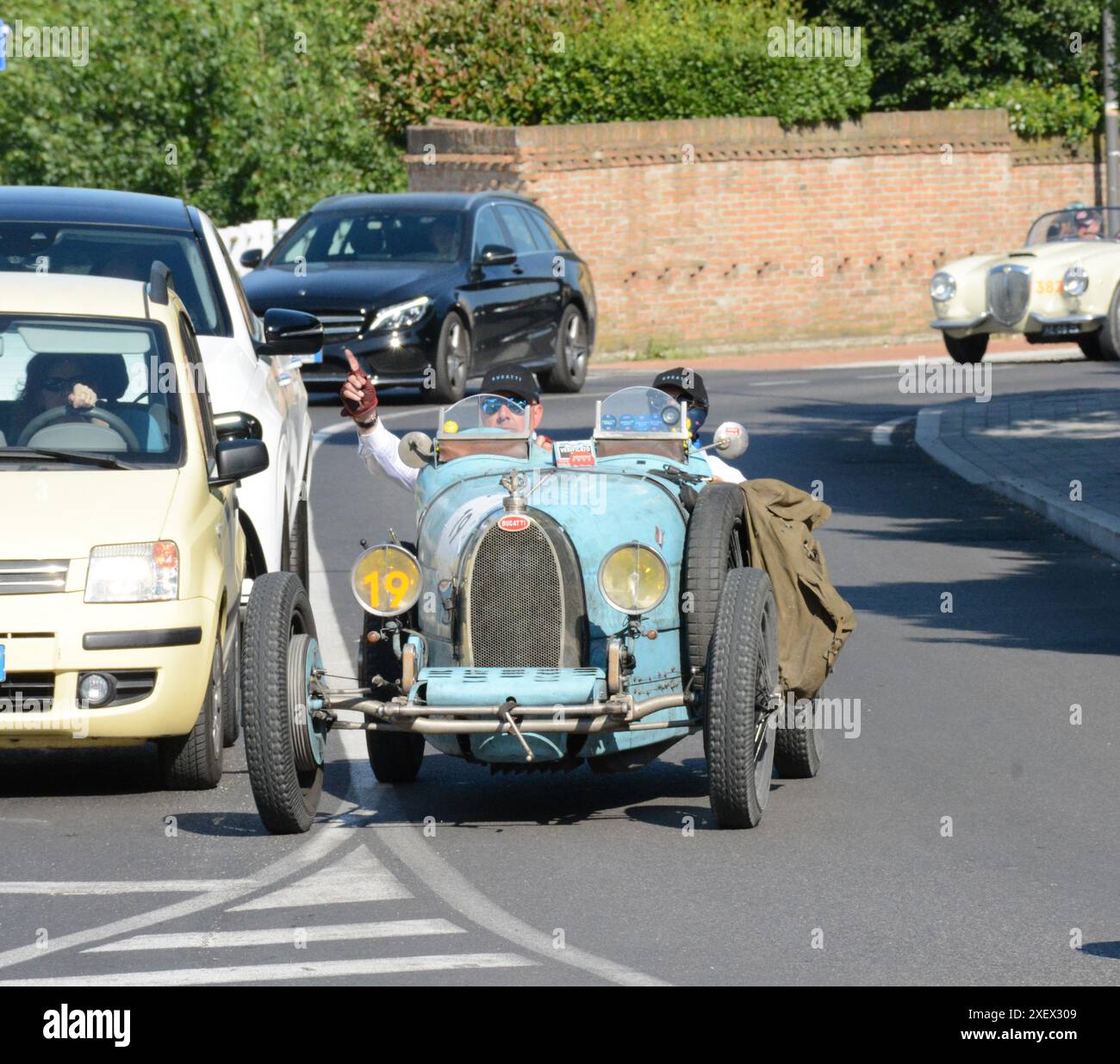 FERRARA , ITALY - jun 15 -2024 : A classic car races through the ...