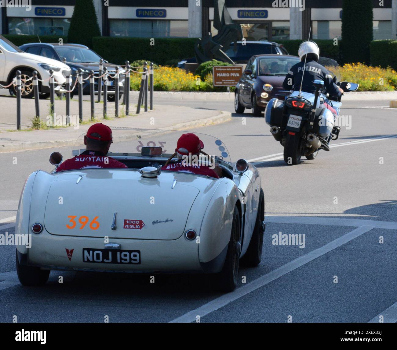 FERRARA , ITALY - jun 15 -2024 : A classic car races through the ...