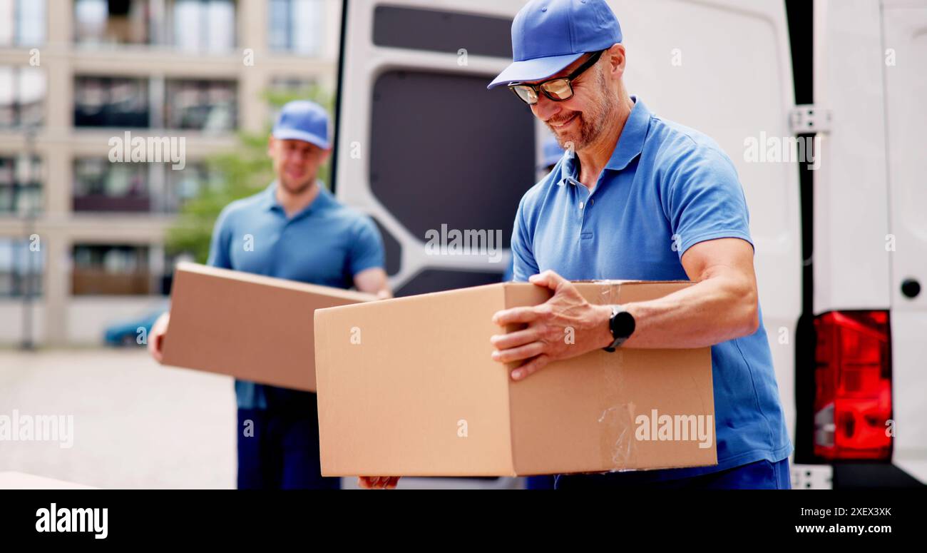 Certified technician unloading van, installing furniture in new home. Professional mover ...