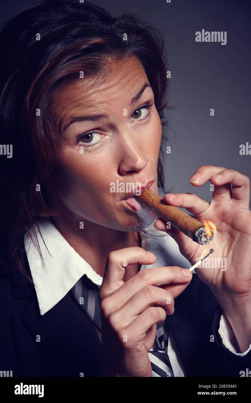 Woman, cigar and smoking in suit or studio, match stick and tobacco ...