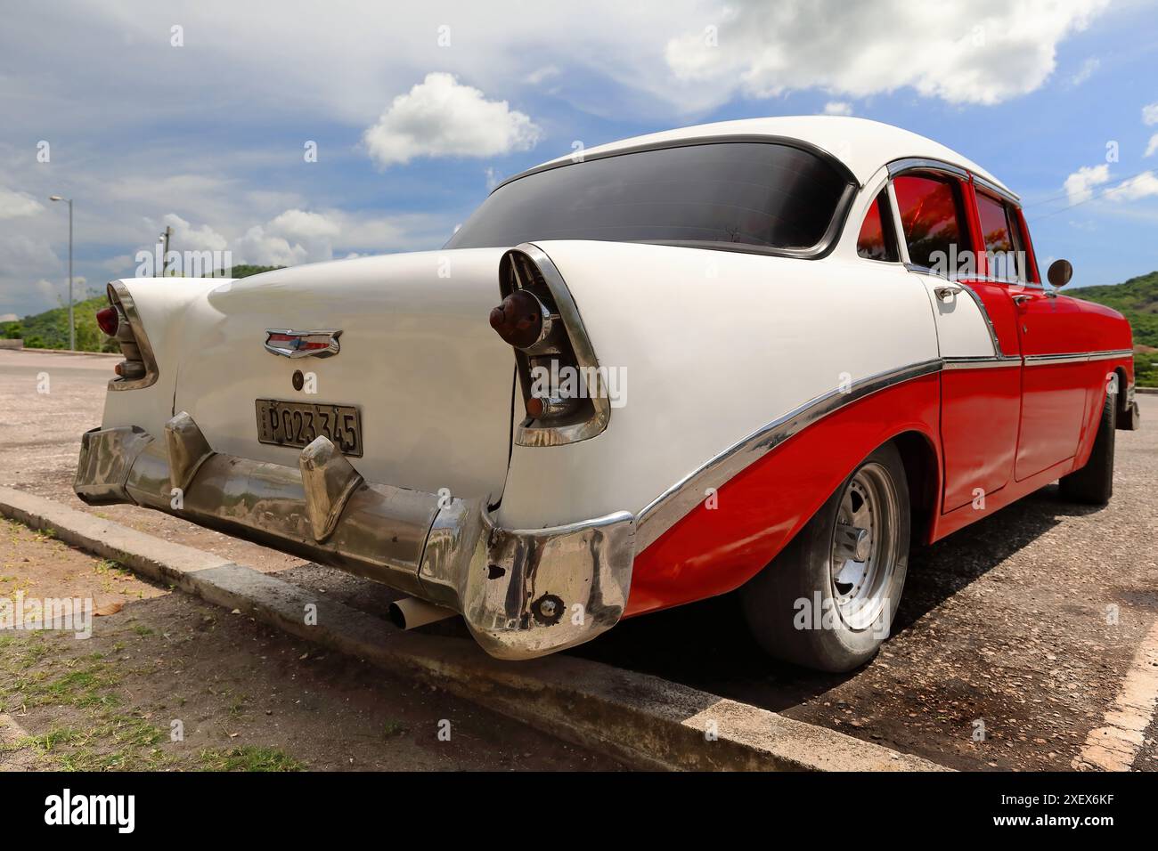 441 Rear and side view, white-roofed red American classic car ...