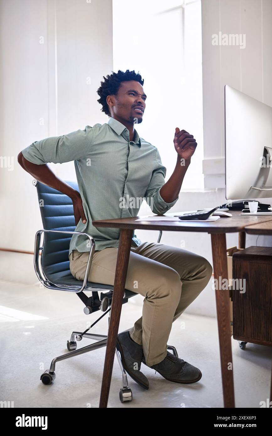 Black man, back pain and injury with computer at office for bad posture ...