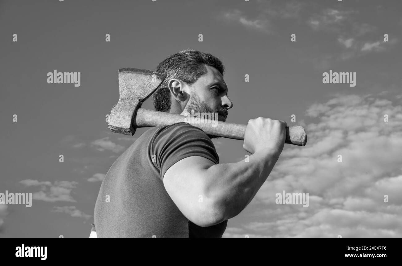 back view of guy with axe. woodman man hold ax. brutal man on sky ...
