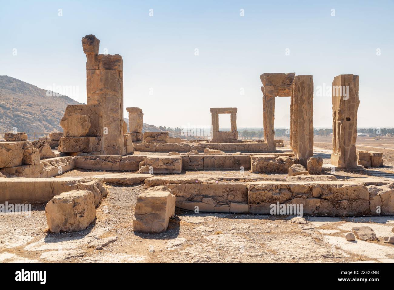 Scenic ruins of the Hadish Palace (the Palace of Xerxes) on blue sky ...