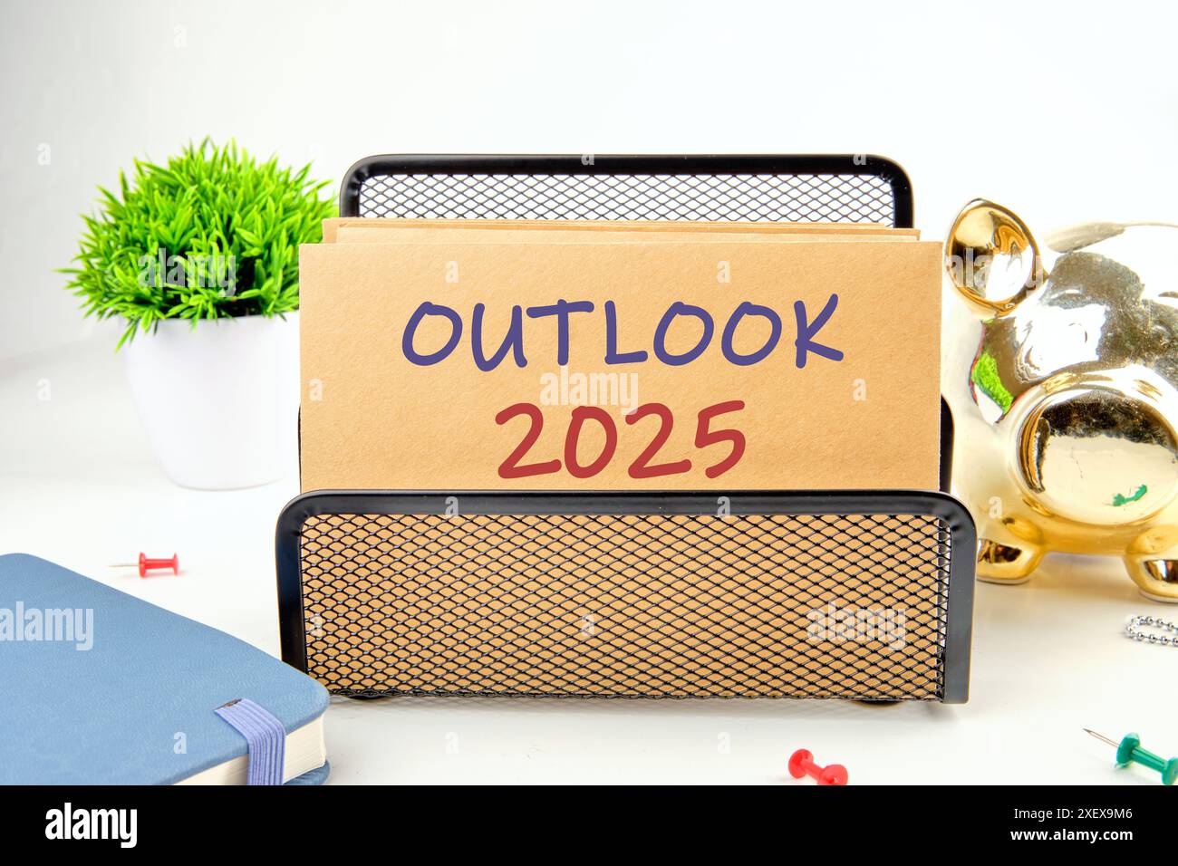 OUTLOOK 2025 on a postal envelope in a stand on a white background ...