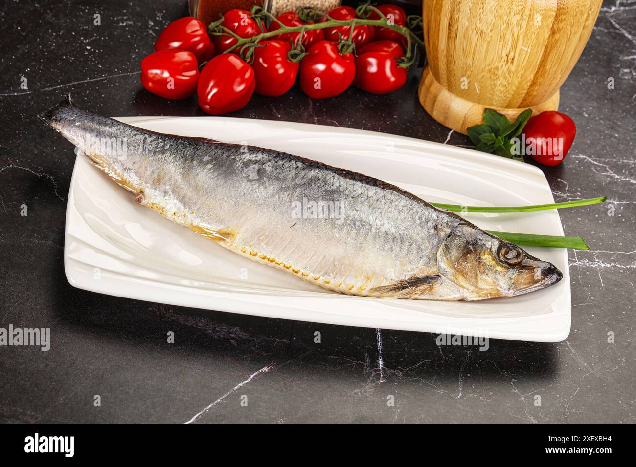 Whole raw salted herring fish in the plate Stock Photo - Alamy