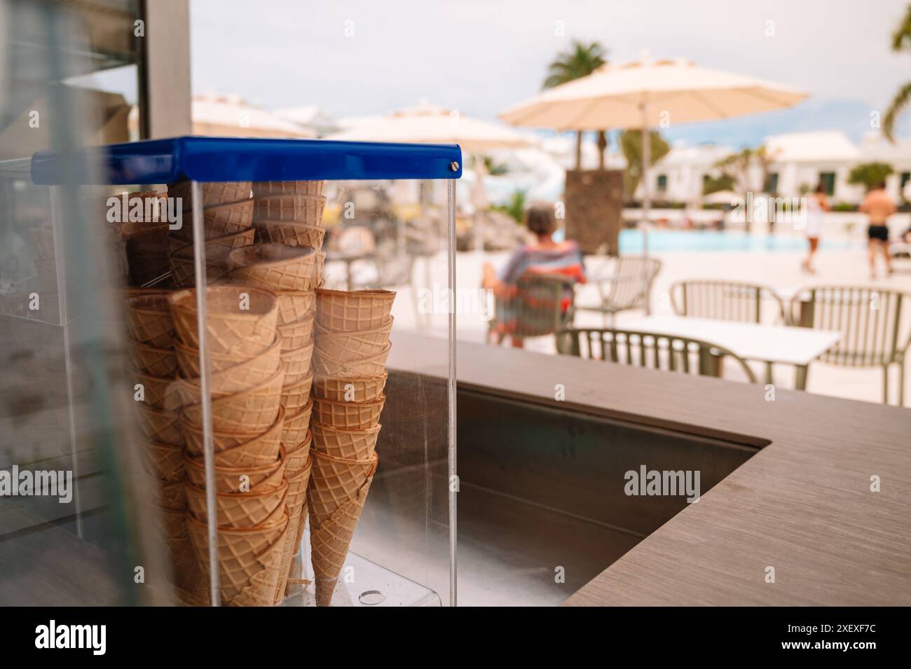 A blue container with ice cream cones inside. The image has a casual ...