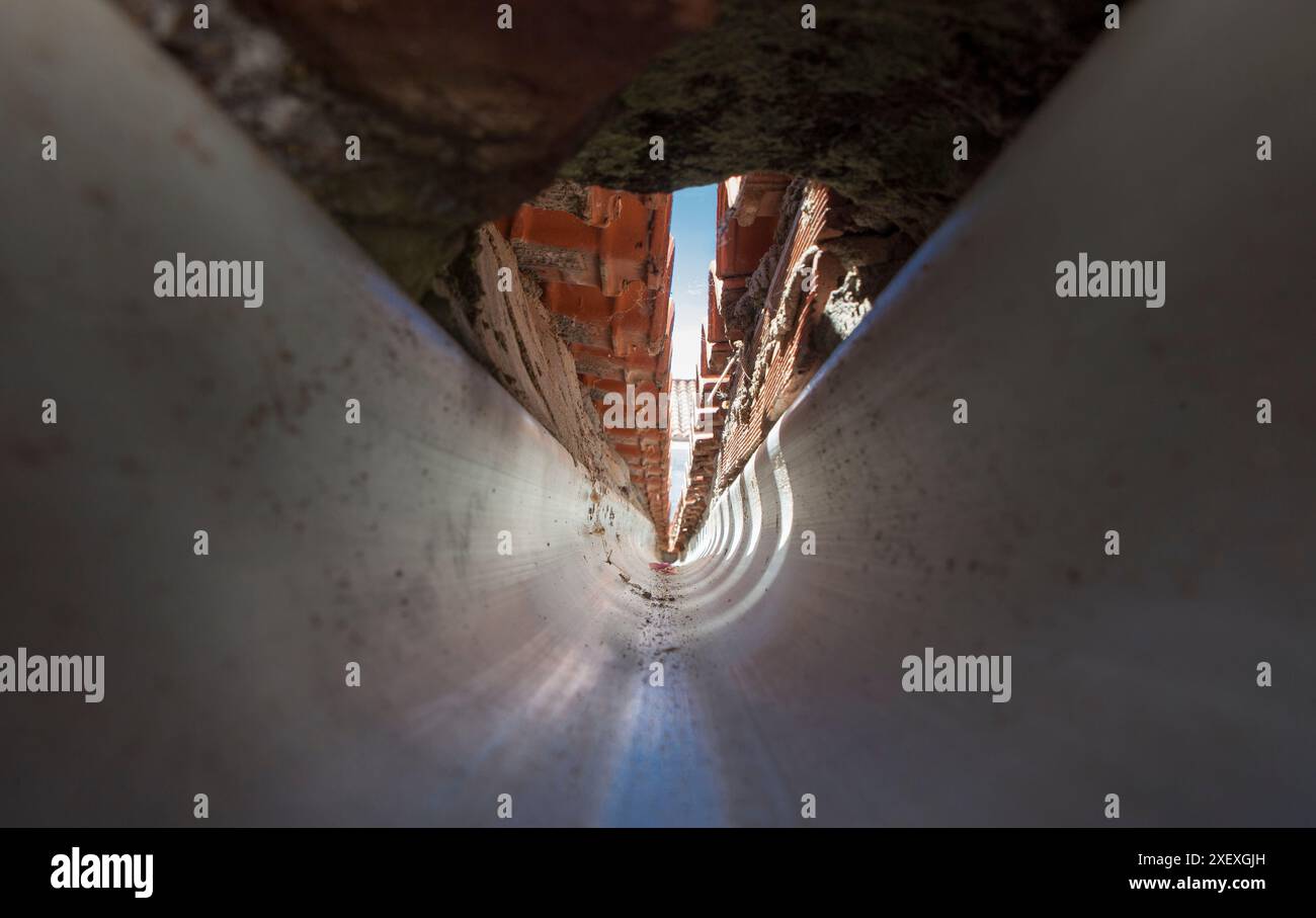 Interior of a PVC gutter at the confluence of a gable roof. tunnel ...