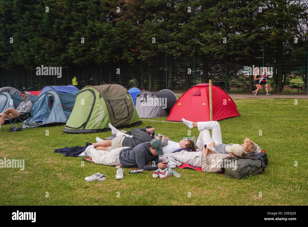 London, UK 30 June 2024. The first tennis fans queue in the early ...
