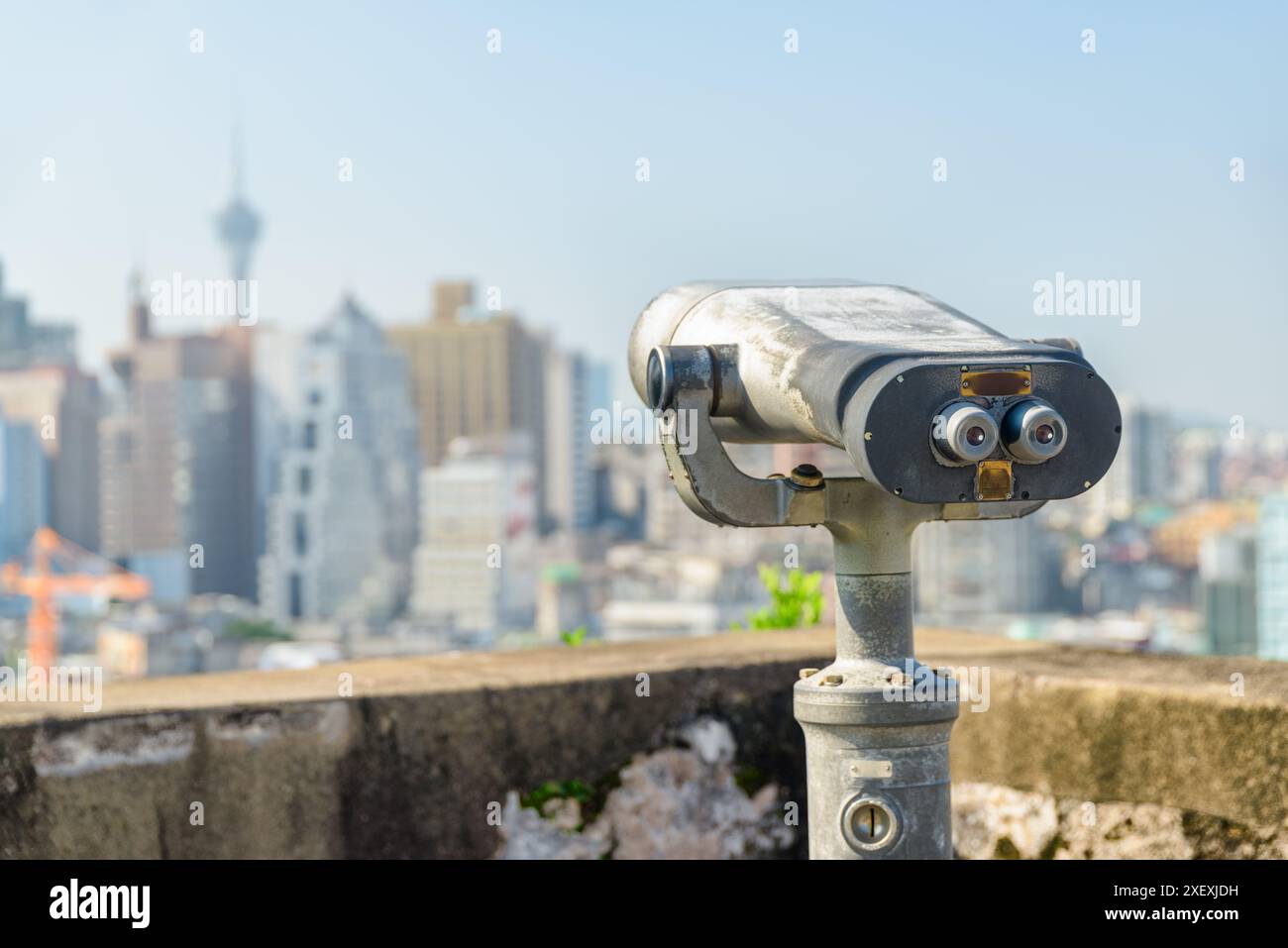 Tower viewer at observation deck in Macau. Coin-operated binoculars ...