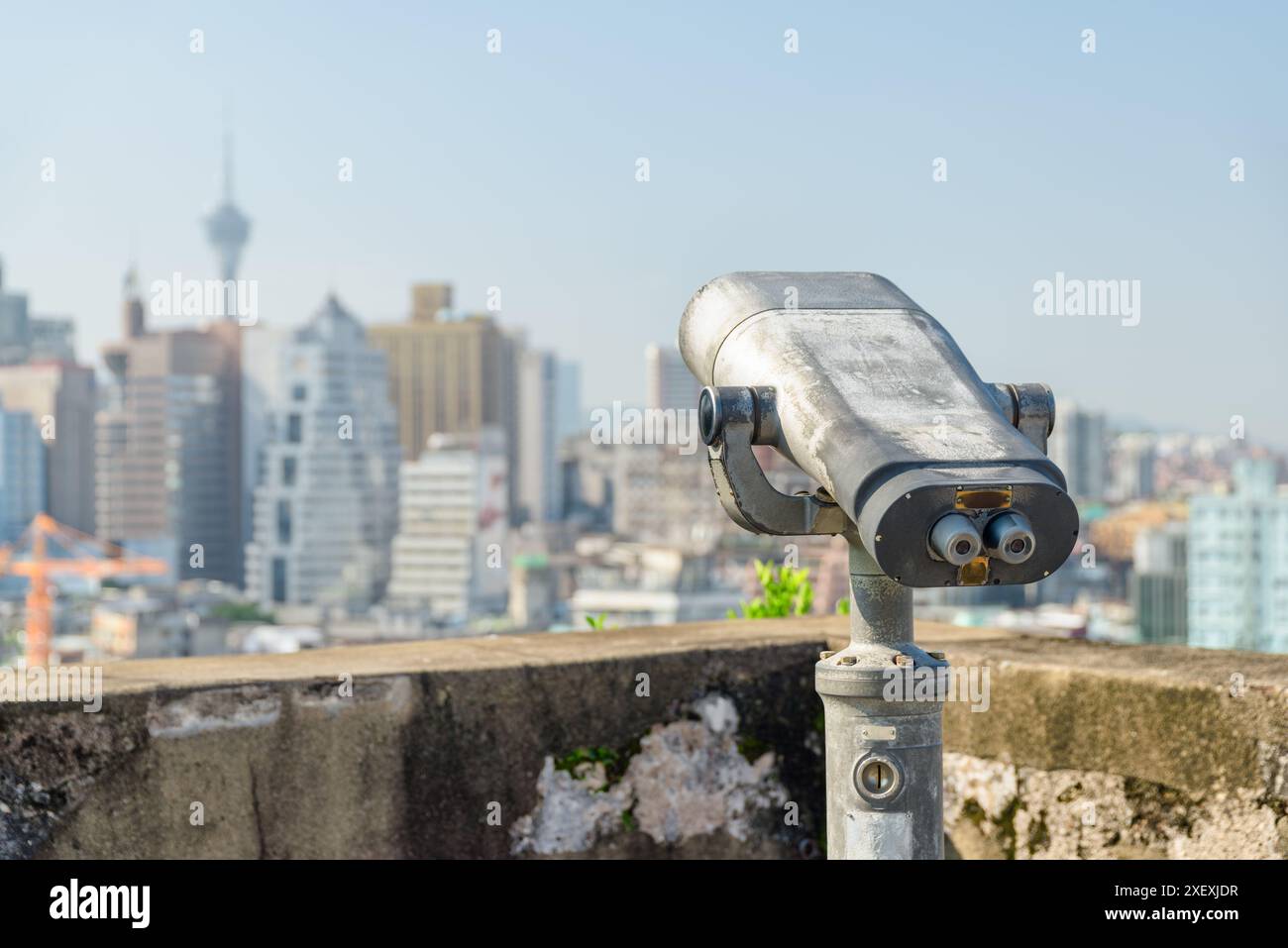 Tower viewer at observation deck in Macau. Coin-operated binoculars ...