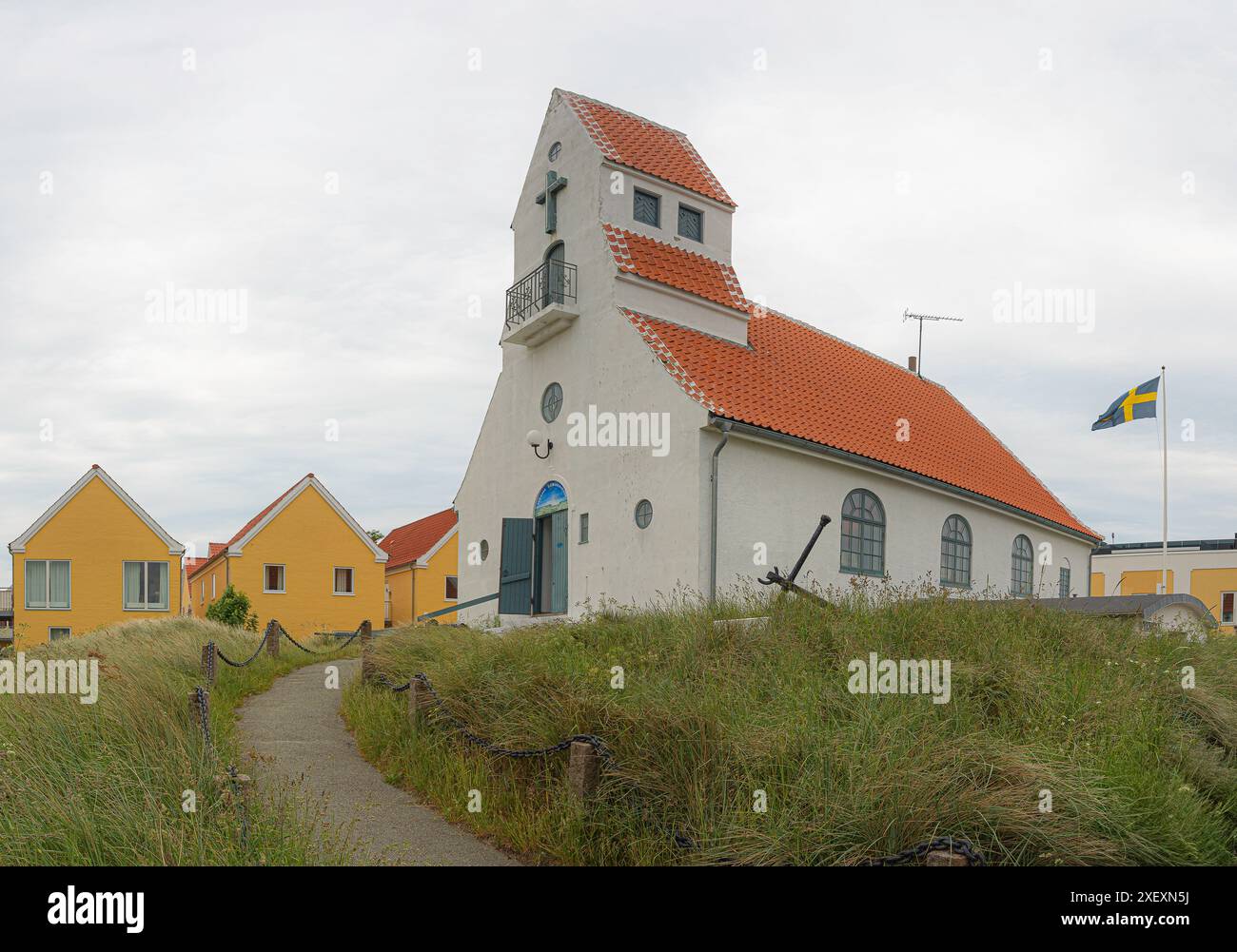 the paved path up to the entrance of the white Swedish Church in Skagen ...