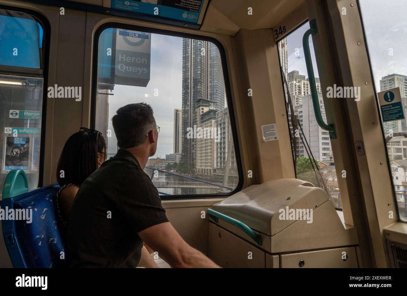 Docklands Light Railway (DLR ) station, with Canary Wharf buildings in ...