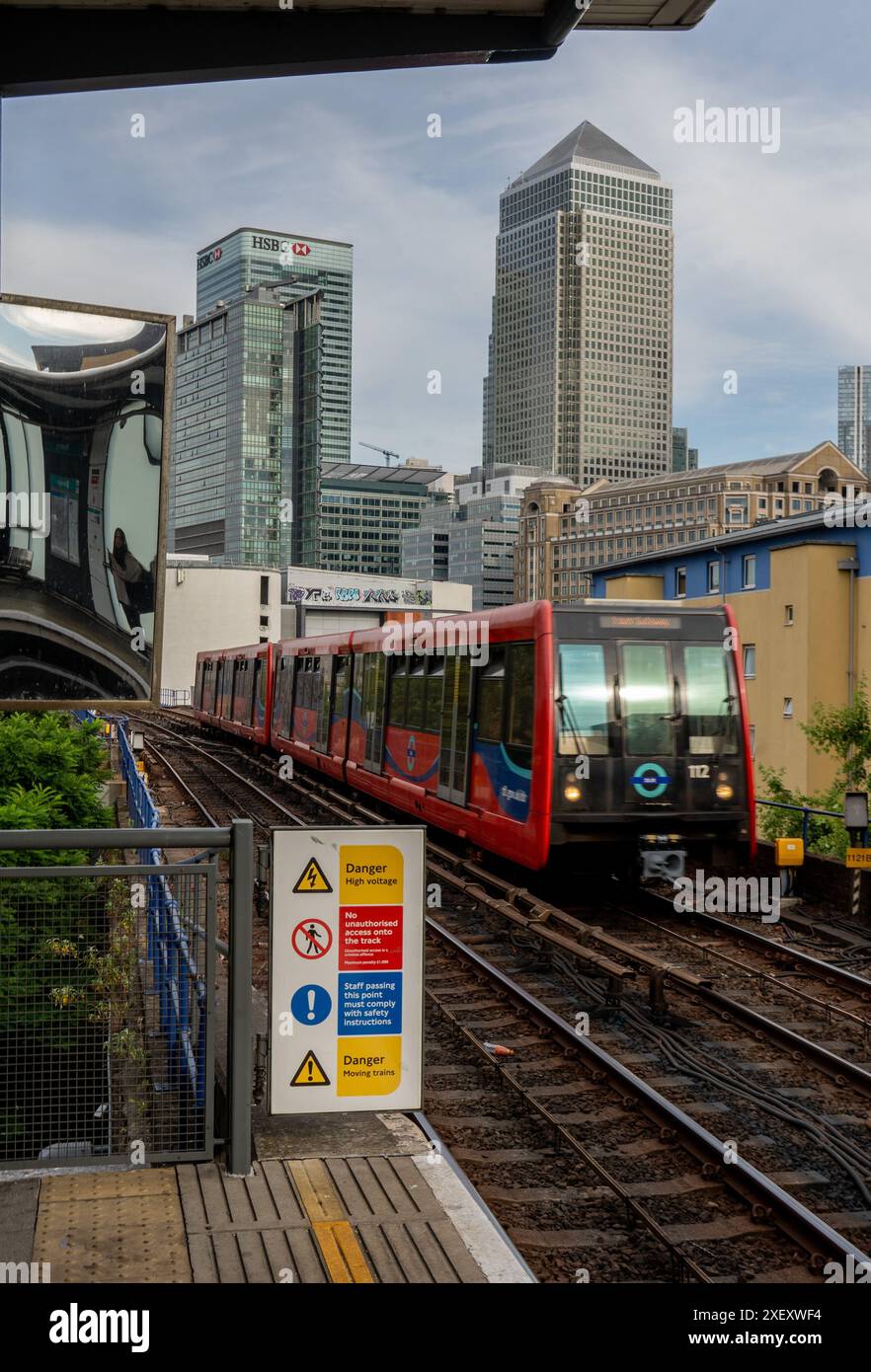 Docklands Light Railway (DLR ) station, with Canary Wharf buildings in ...