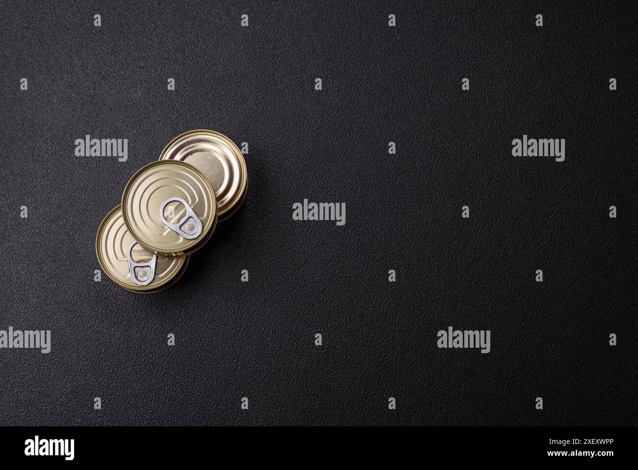 Round metal can with canned meat or fish with a key to open it on a ...