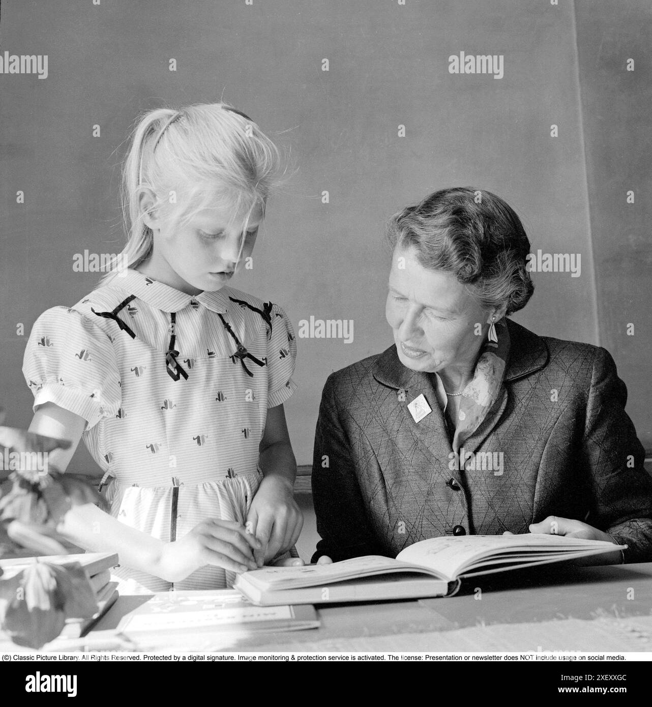 School in the 1950s. A girl with her teacher. Sweden 1957 Conard ref ...