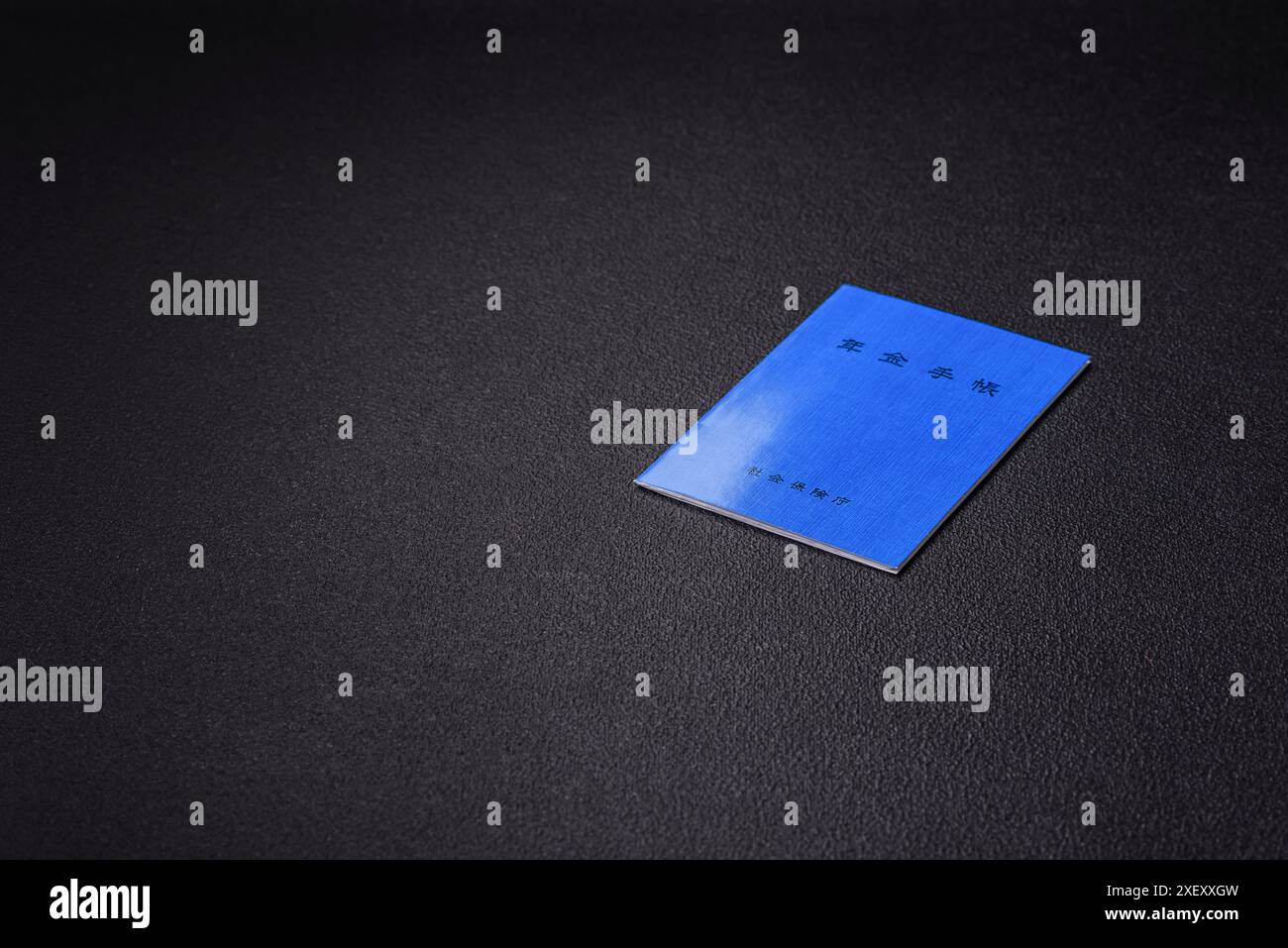 Pension book or Japanese citizen ID card on dark concrete background ...