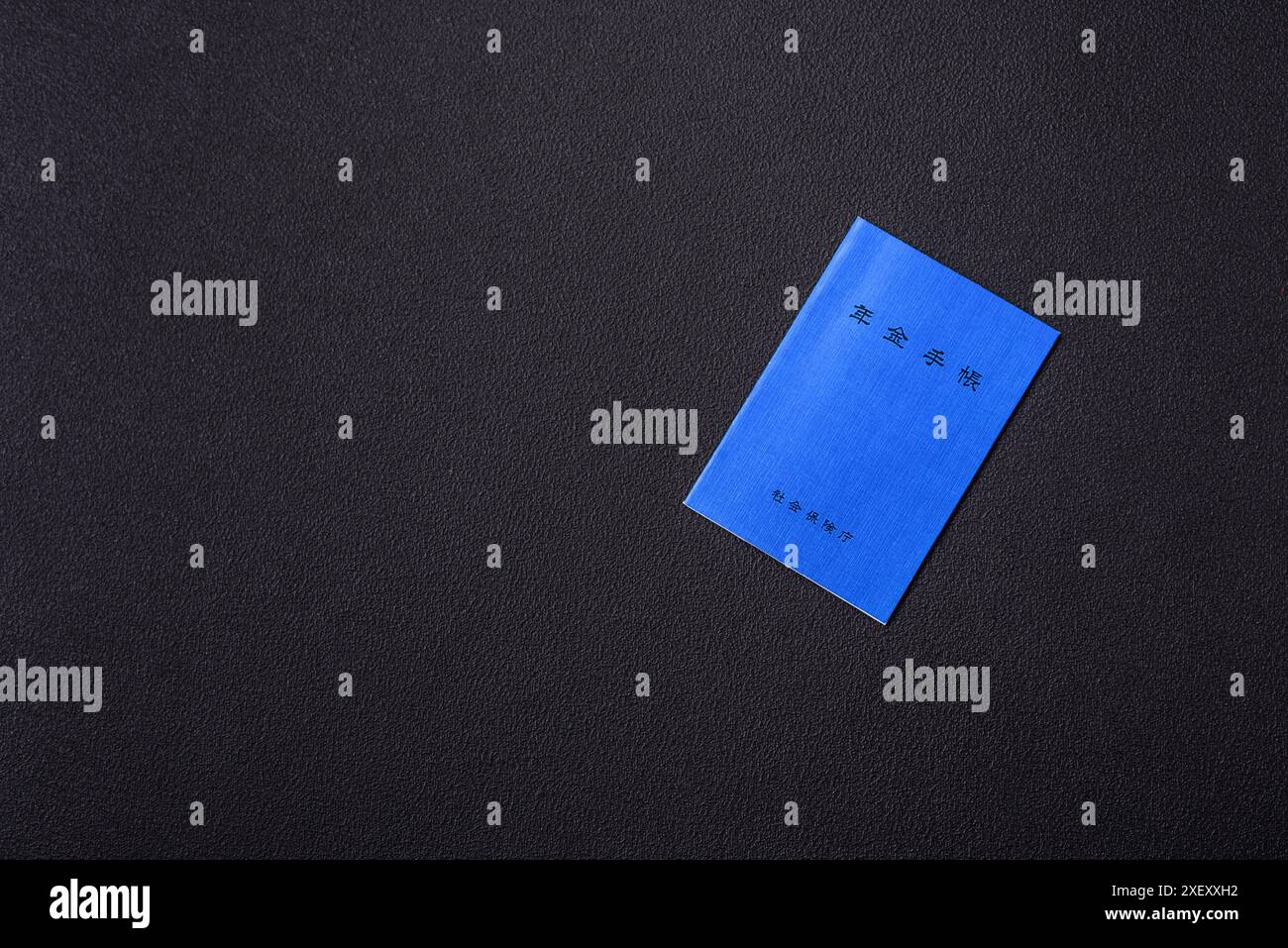 Pension book or Japanese citizen ID card on dark concrete background ...