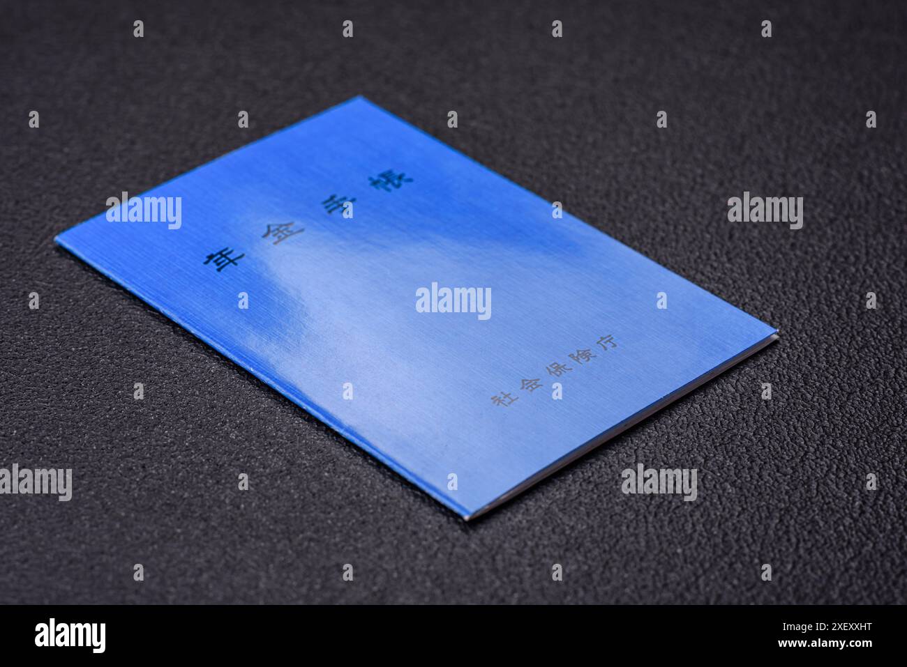 Pension book or Japanese citizen ID card on dark concrete background ...
