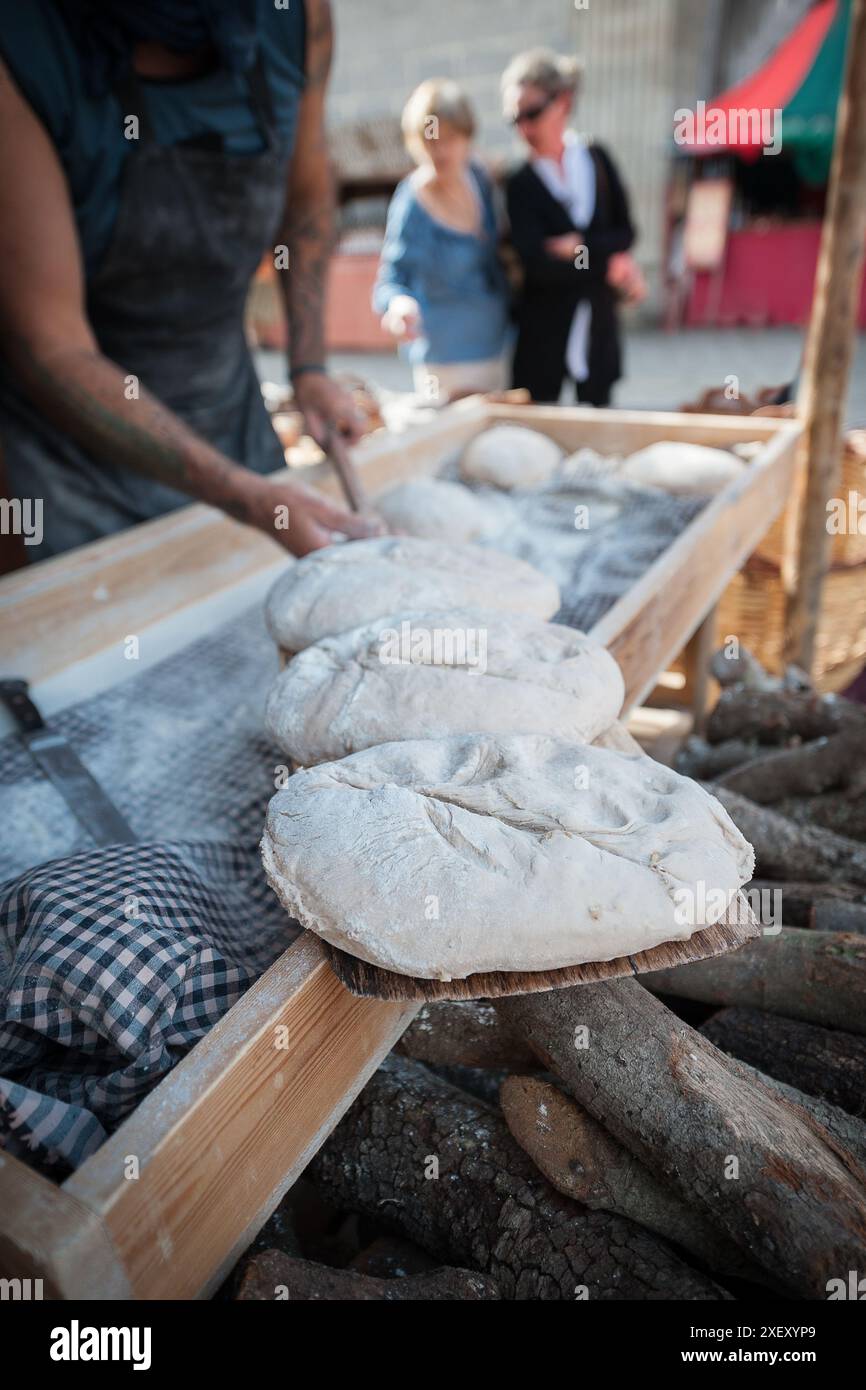 introducing mass baker of bread in wood stove Stock Photo - Alamy