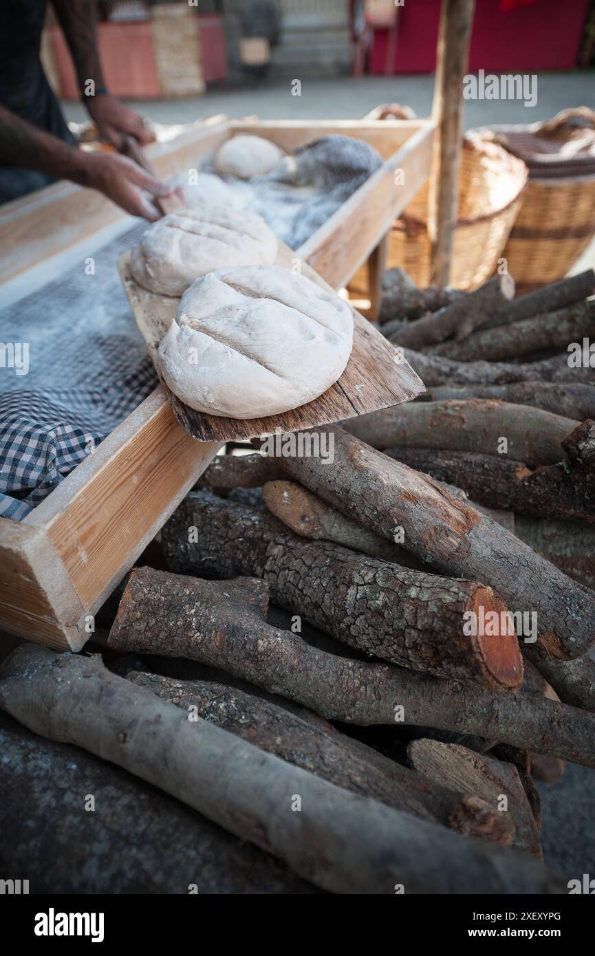 introducing mass baker of bread in wood stove Stock Photo - Alamy