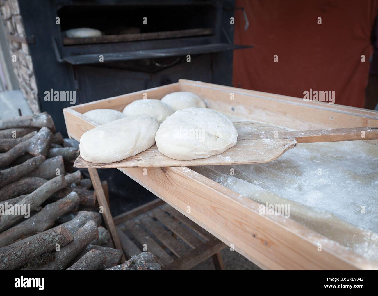 introducing mass baker of bread in wood stove Stock Photo - Alamy