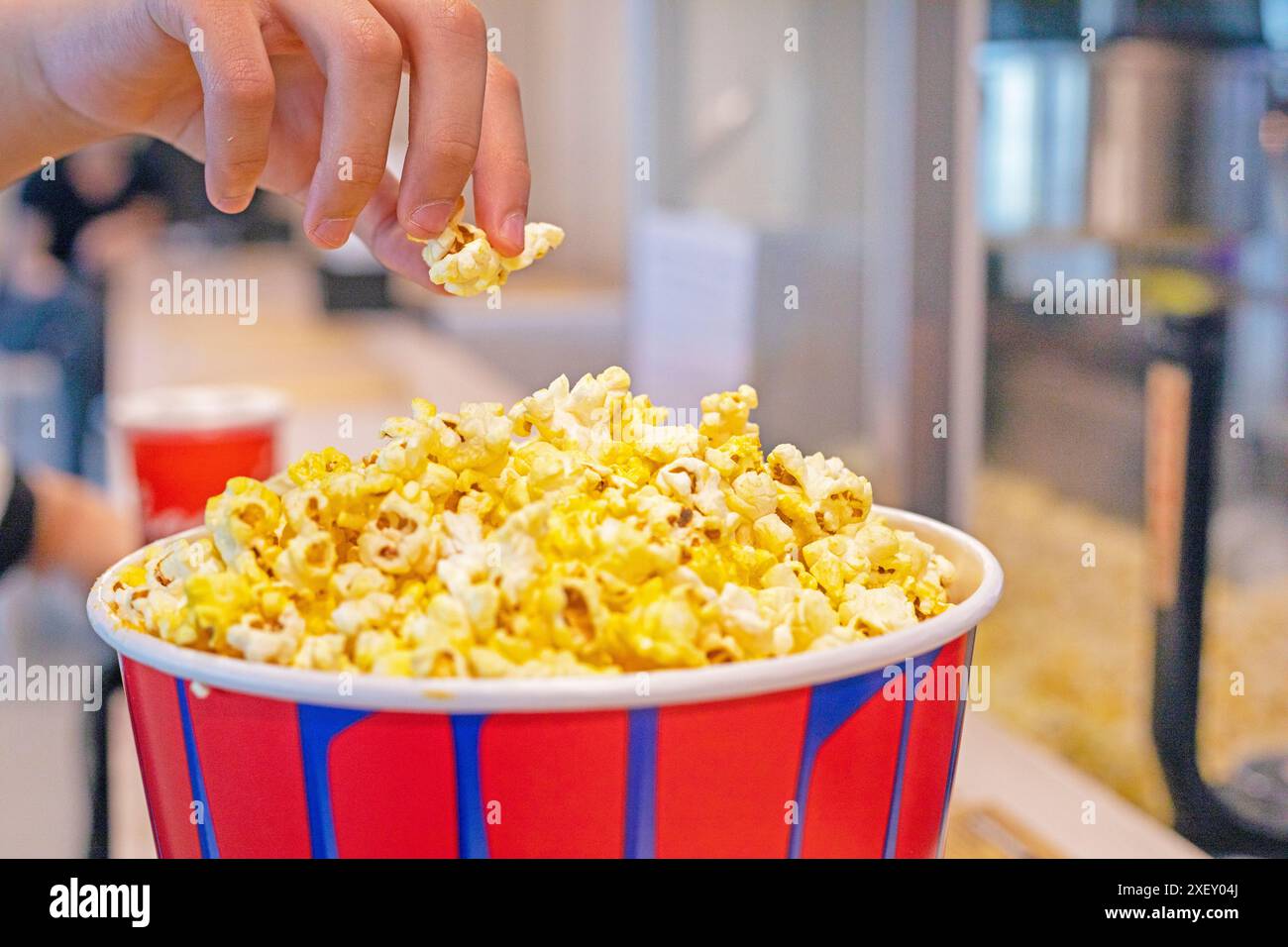 taste classic popcorn before watching a movie. Family day out Stock ...