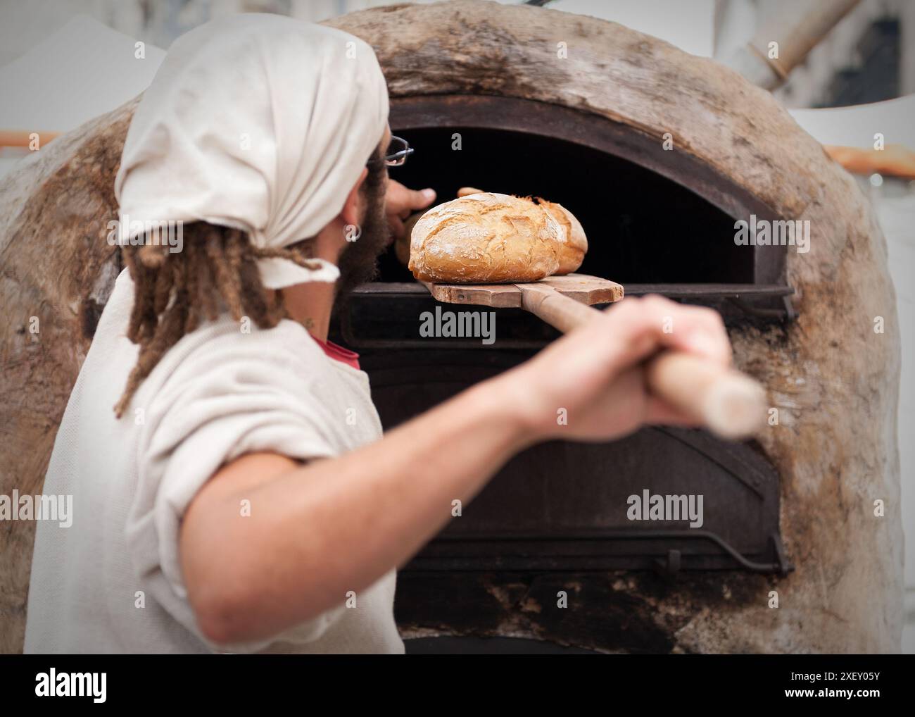 introducing mass baker of bread in wood stove Stock Photo - Alamy