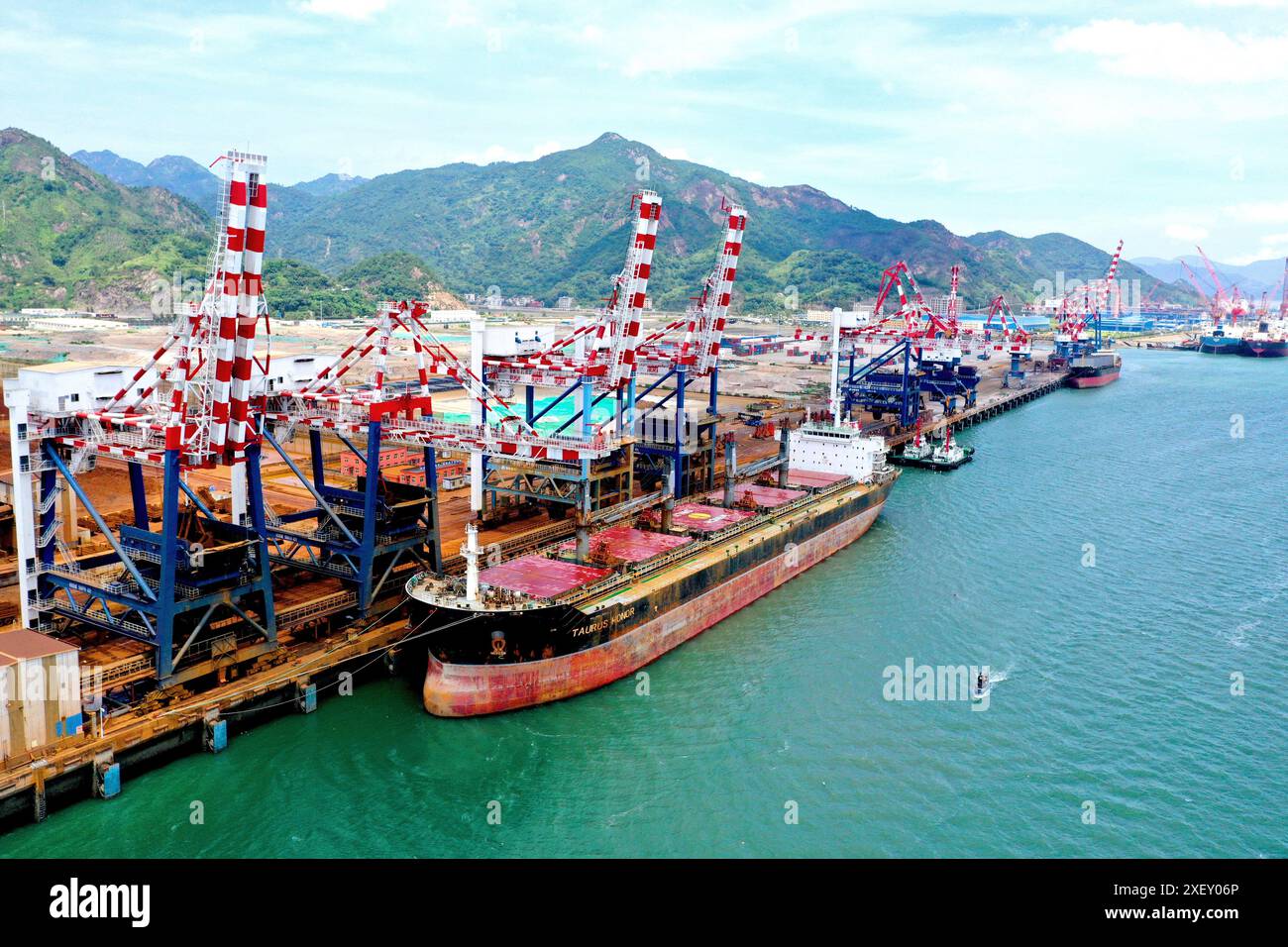 FUZHOU, CHINA - JUNE 30, 2024 - Vehicles shuttle back and forth with ...
