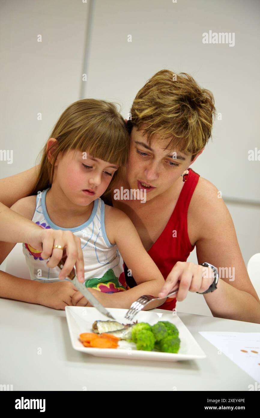 Mother and daughter eating vegetables, tasting session in sensory ...