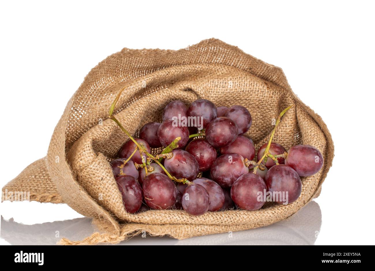 Bunch of sweet grapes in jute sack, macro, isolated on white background ...