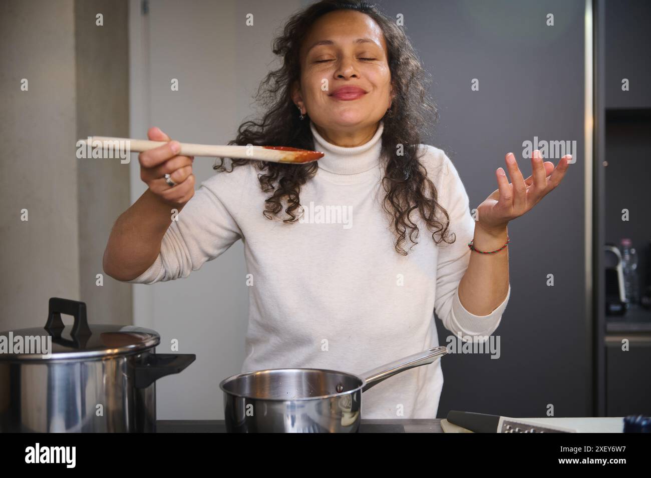 Beautiful Italian woman expressing positive emotion, tasting tomato ...