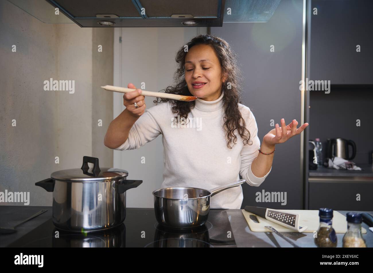 Woman preparing Italian spaghetti according to traditional recipe ...