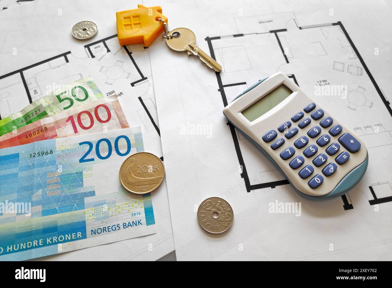 Close-up on some Norwegian krone (NOK) banknotes, a home key and a ...