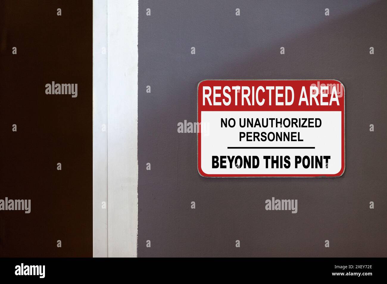 Red and white restricted area sign on the side of an open door stating ...