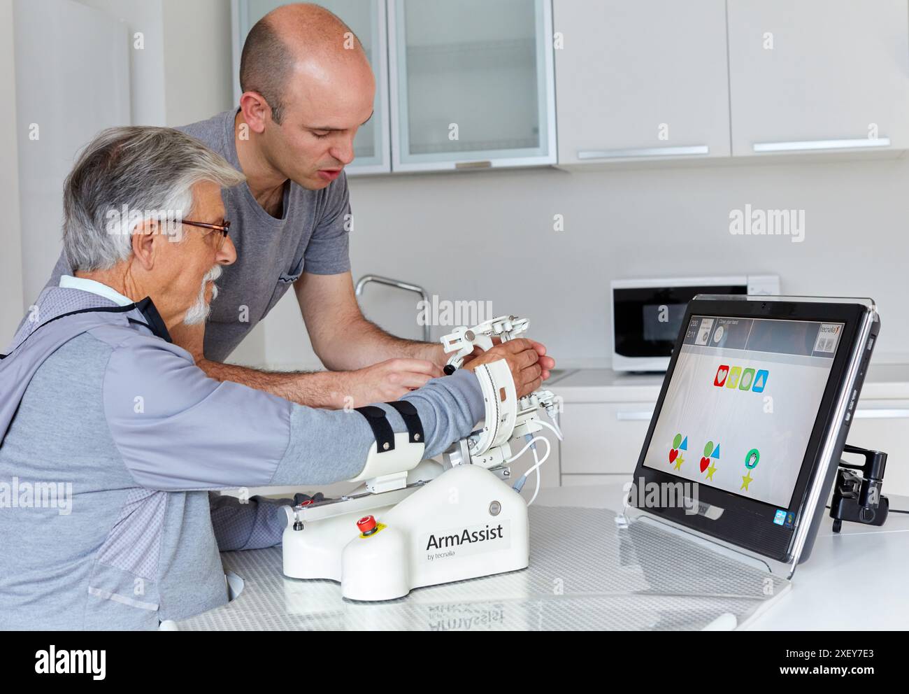Patient with assistive robot for upper limb rehabilitation, The robot ...