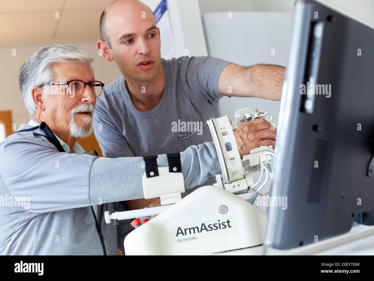 Patient with assistive robot for upper limb rehabilitation, The robot ...