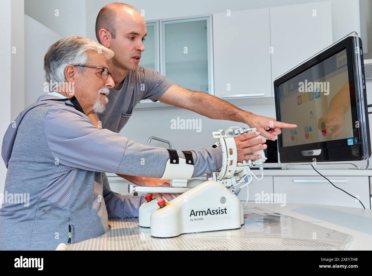 Patient with assistive robot for upper limb rehabilitation, The robot ...