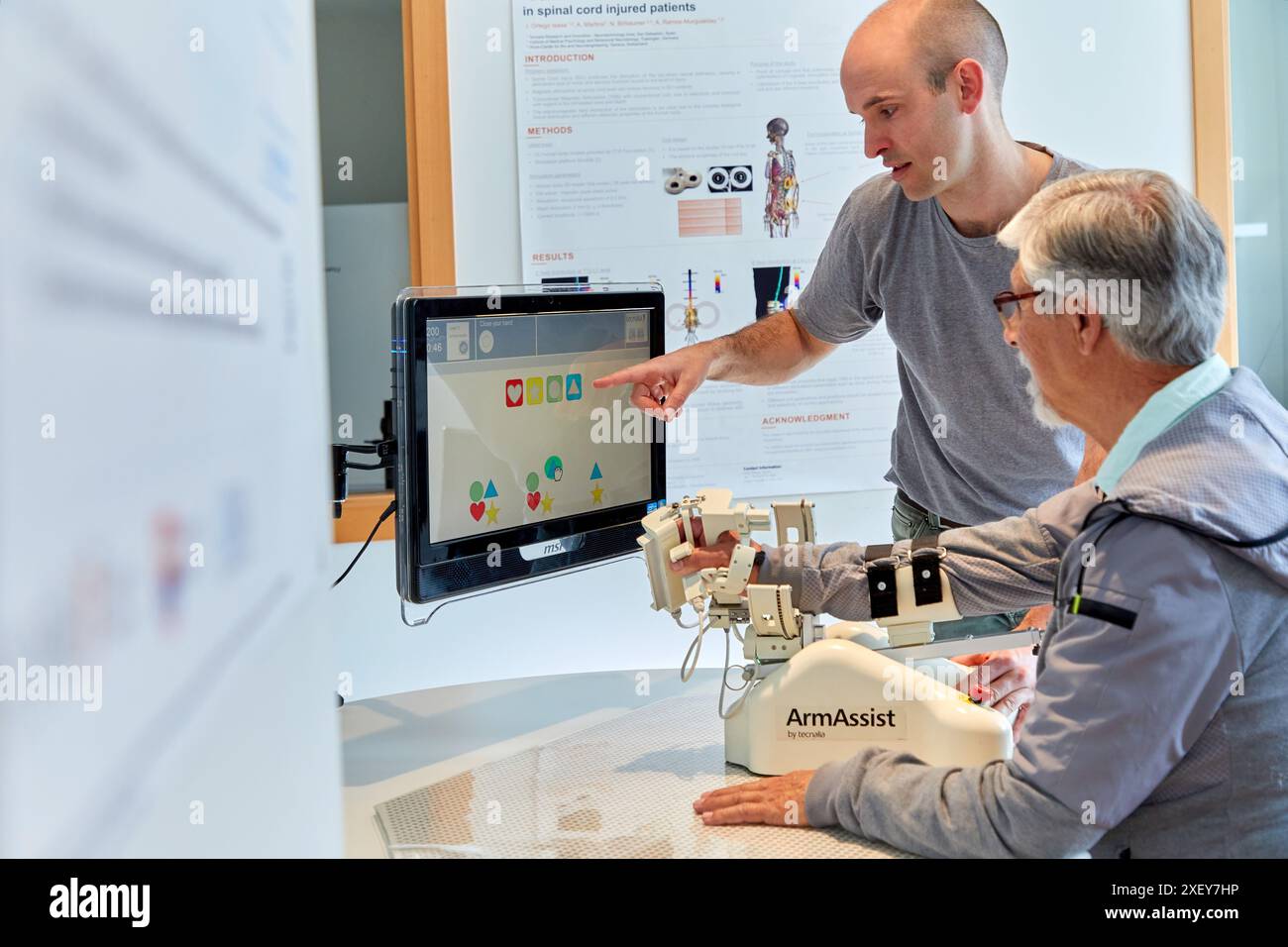 Patient with assistive robot for upper limb rehabilitation, The robot ...