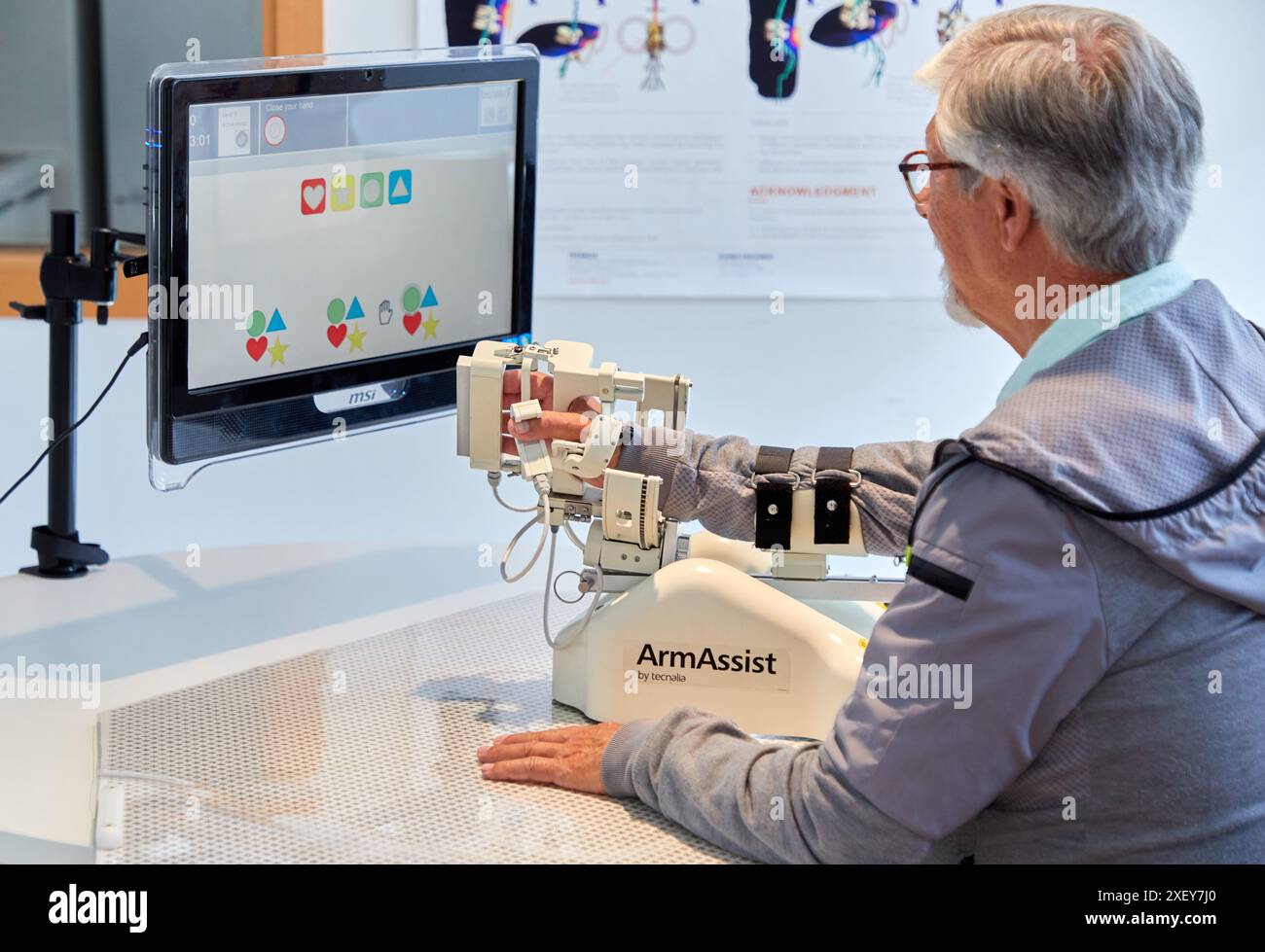 Patient with assistive robot for upper limb rehabilitation, The robot ...