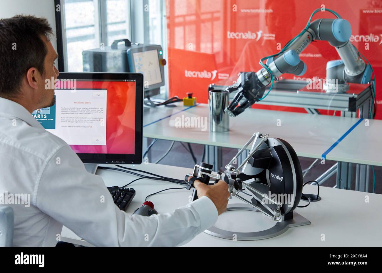 Robot composed of two pieces, a robotic arm, motorized by a clamp to ...