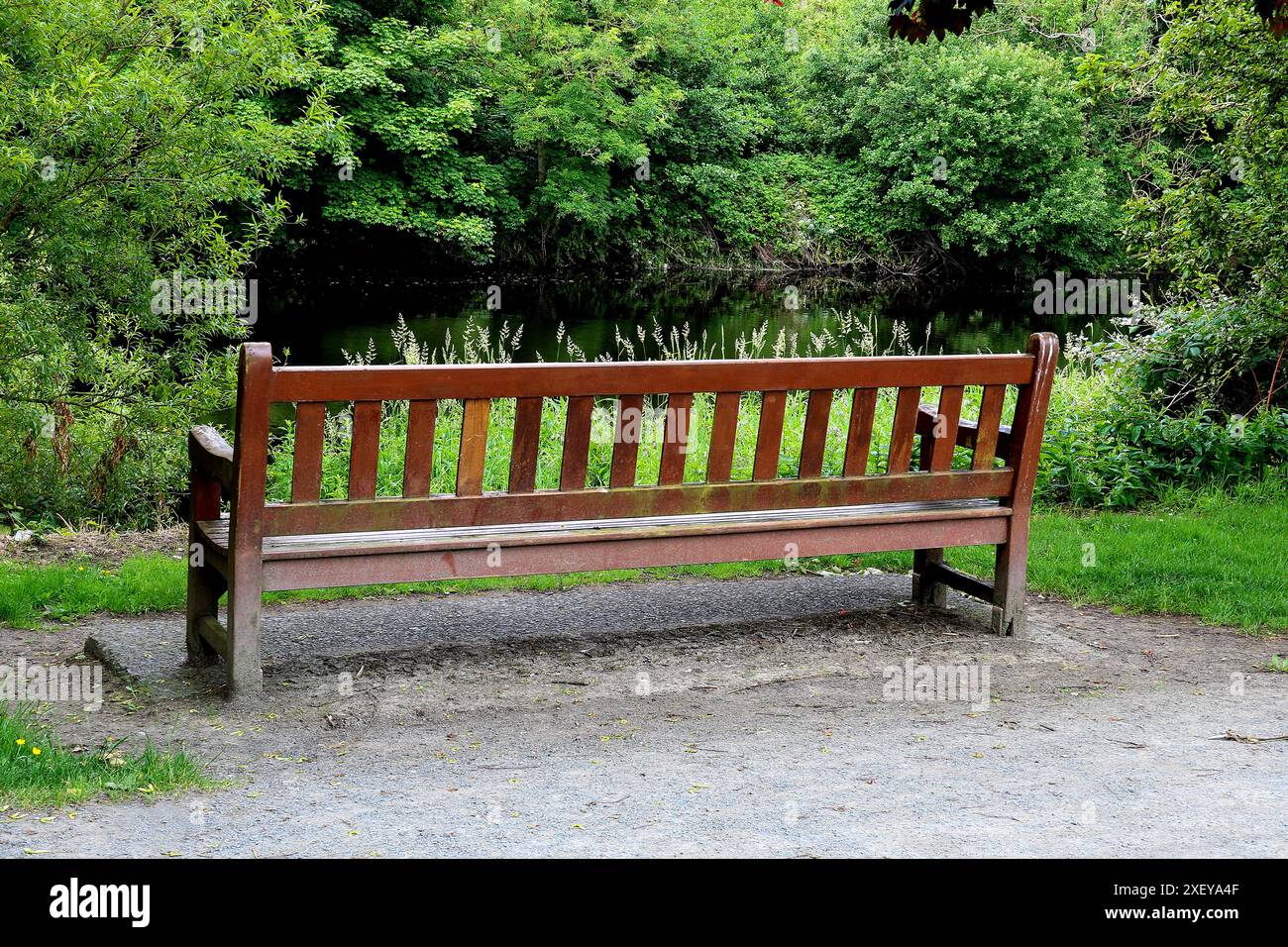 Wooden bench seat situated at a riverside country footpath Stock Photo ...