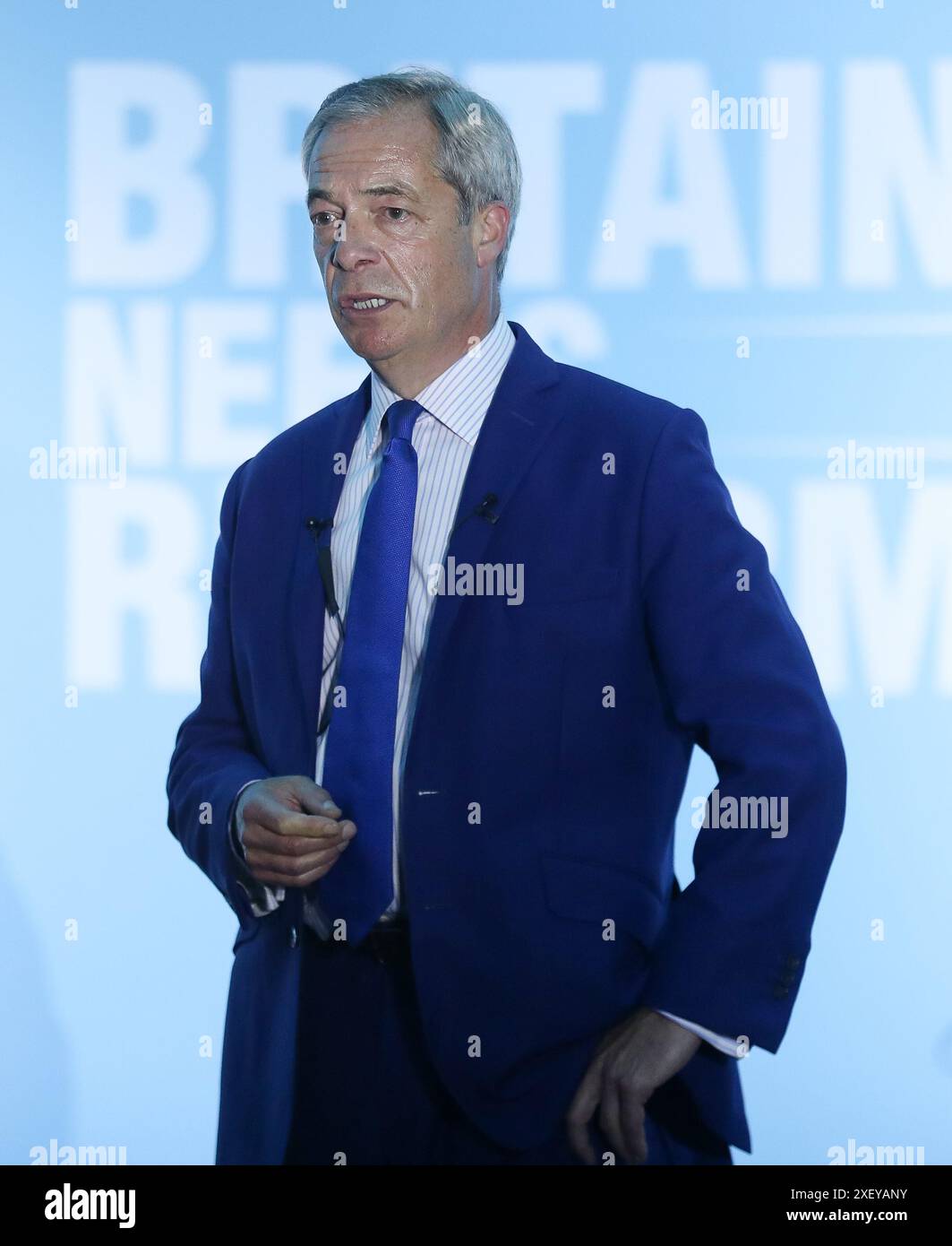 Reform UK leader Nigel Farage speaking at an event at the Imperial ...