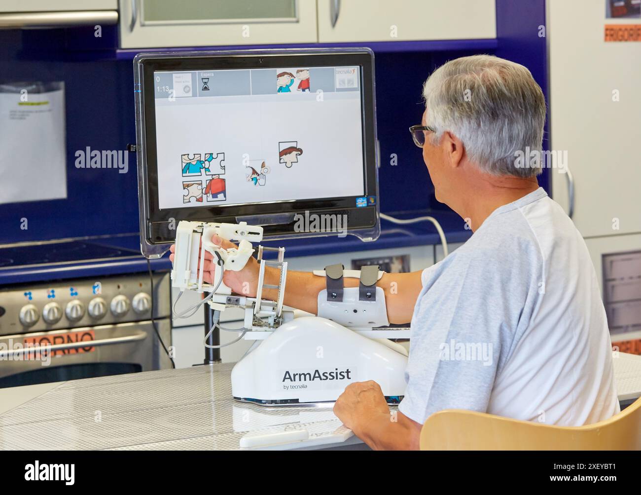 Patient with assistive robot for upper limb rehabilitation, The robot ...