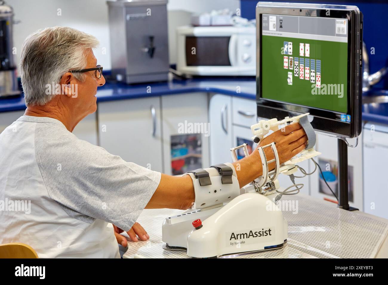 Patient with assistive robot for upper limb rehabilitation, The robot ...