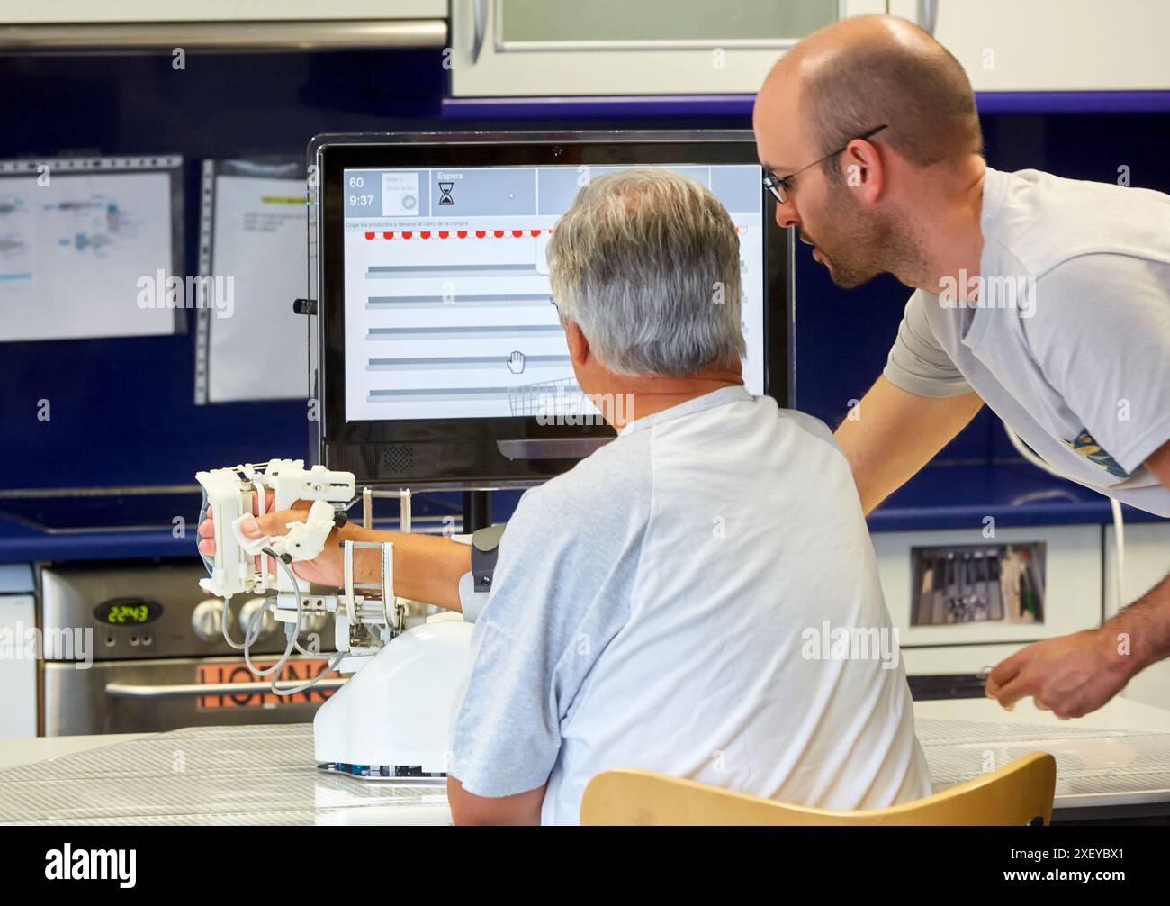 Investigator and patient with assistive robot for upper limb ...