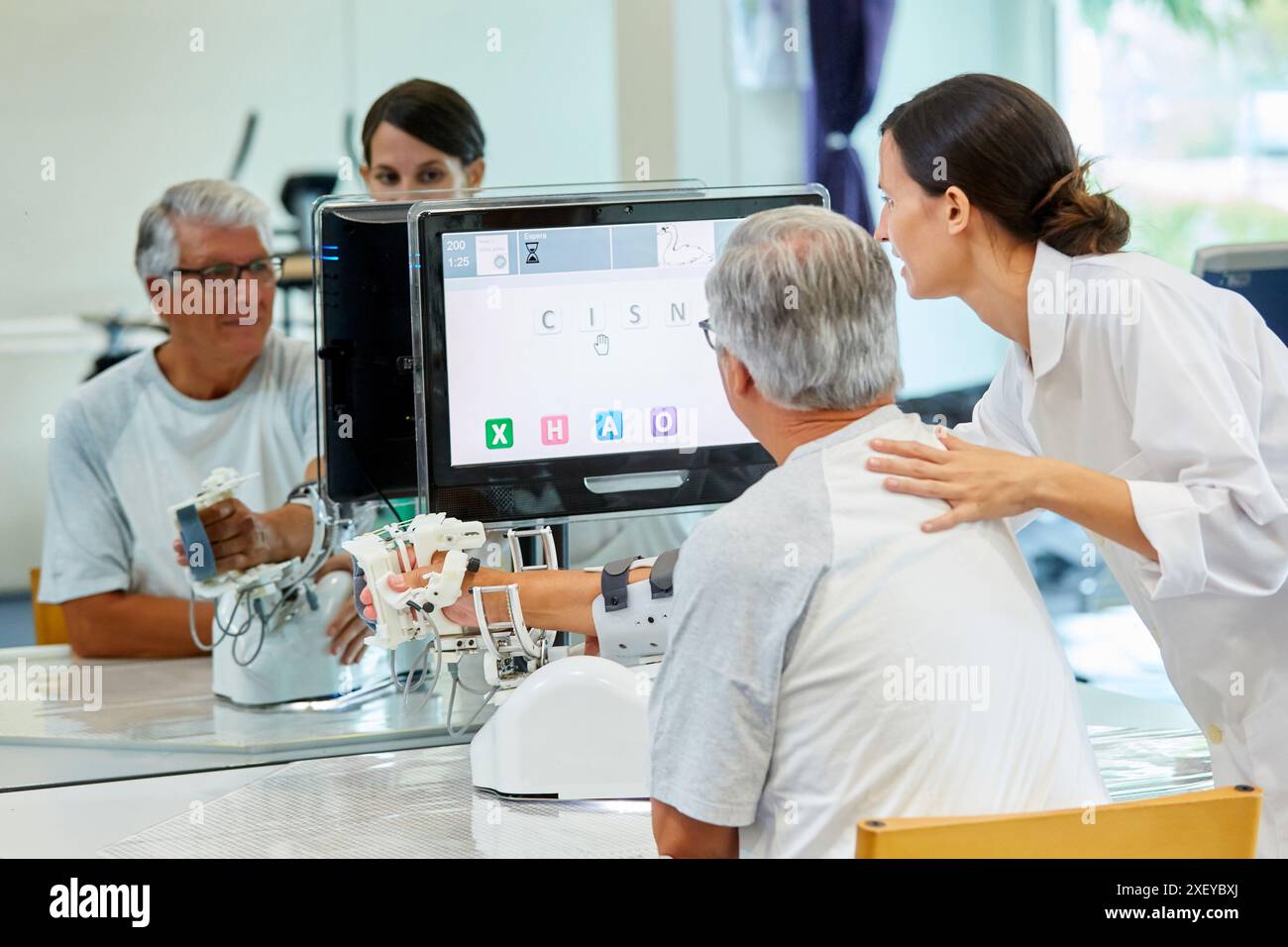 Therapist and patient with assistive robot for upper limb ...