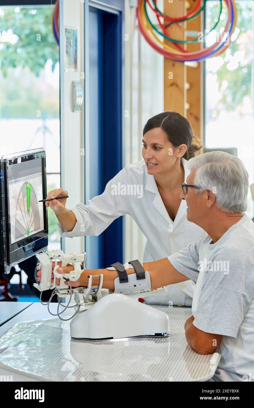 Therapist And Patient With Assistive Robot For Upper Limb